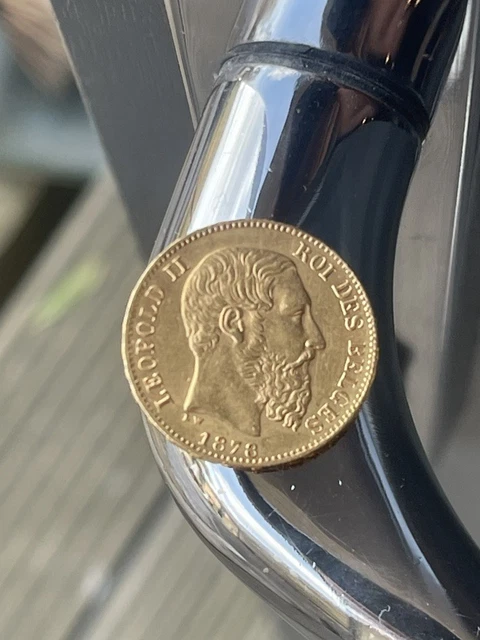 A 21.6CT BELGIAN 20 Francs gold coin featuring A portrait of King ...