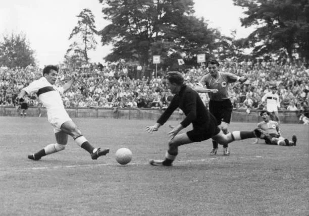 THE GERMAN GOALKEEPER Toni Turek who rushes out goal overcome by T ...